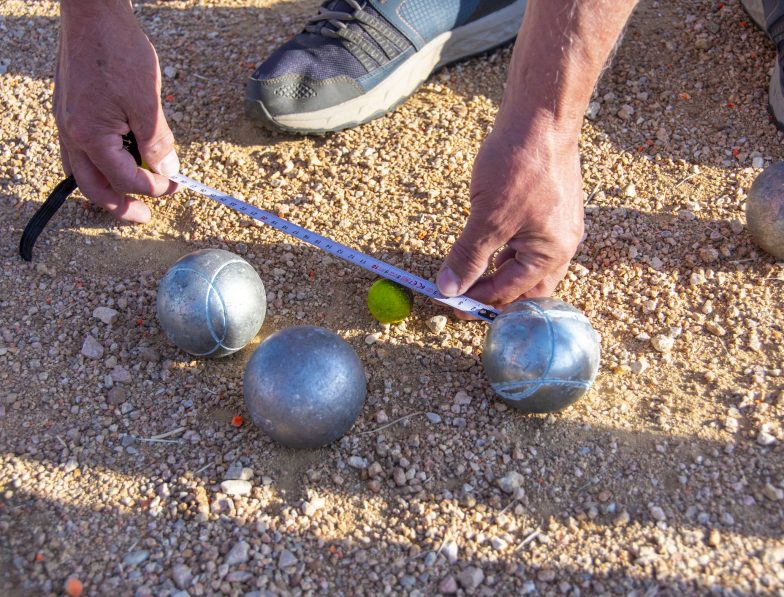 Measuring with a measuring tape in the game of Petanque (boule)